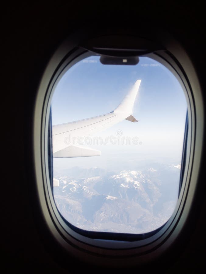 Airplane Window View with Wing and Mountains Stock Photo - Image of ...