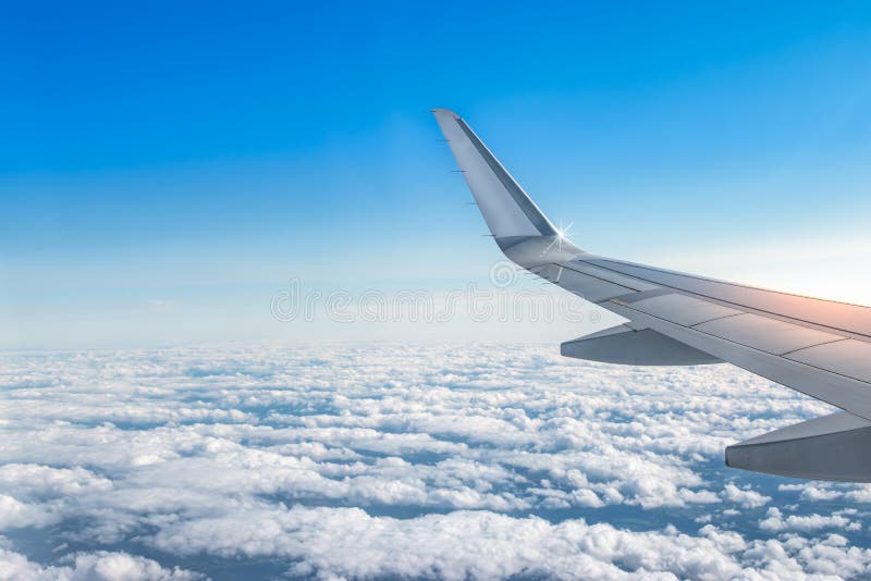 Airplane Wing Above the Clouds at Sunrise. Stock Photo - Image of ... Airplane Wing Above the Clouds at Sunrise. Stock Photo - Image of ...