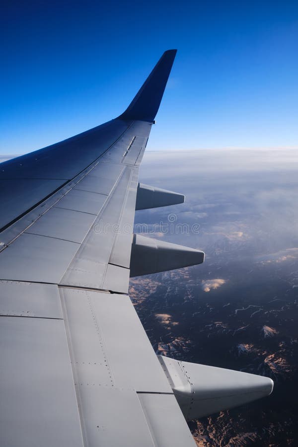 Airplane Wing Above Mountains at Sunset Vertical View Stock Image ...