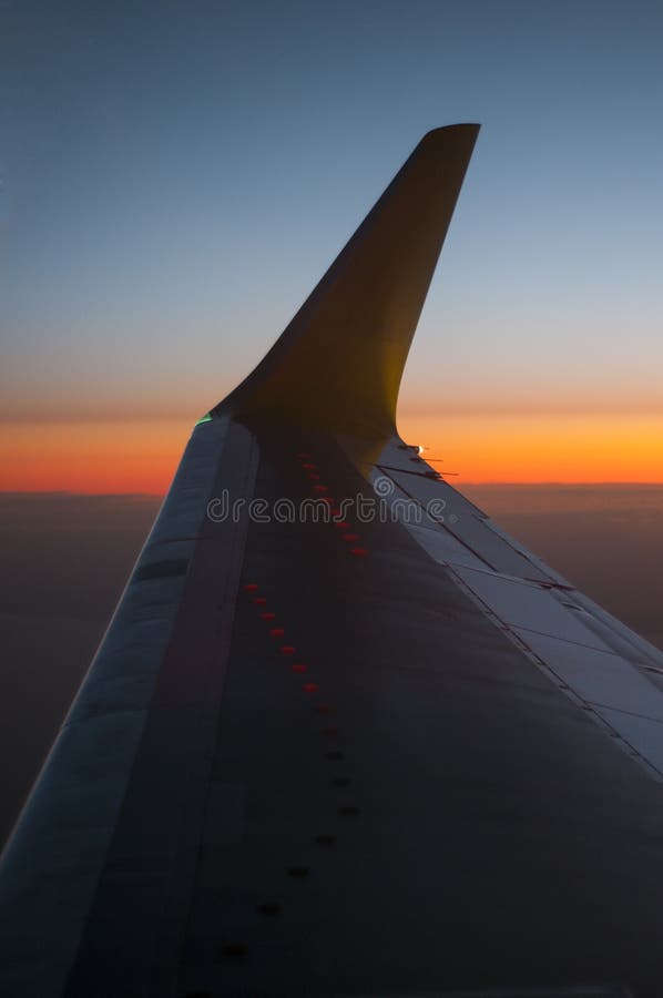 Airplane Wing on the Background of a Beautiful Sunrise. Stock Photo ...