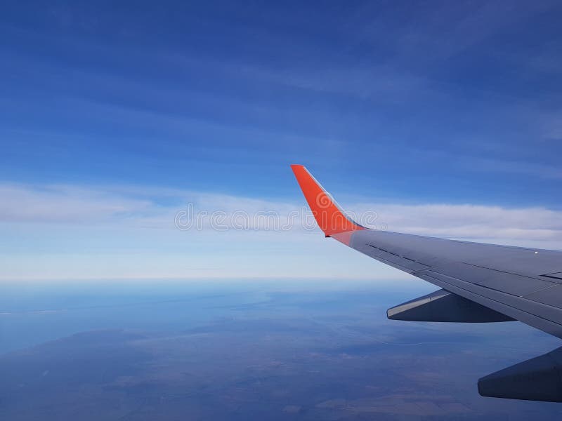 Airplane wing in blue sky stock photo. Image of lighting - 199845140