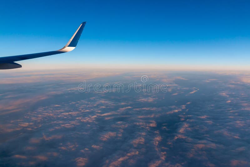 Airplane Wing Over Clouds in the Evening Stock Photo - Image of flight ...
