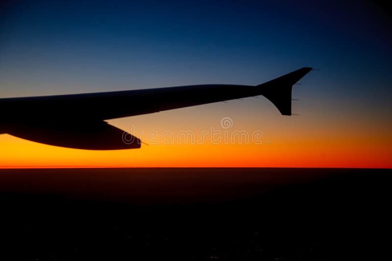 Airplane Wing and the Colors of Sunset or Sunrise Stock Image - Image ...