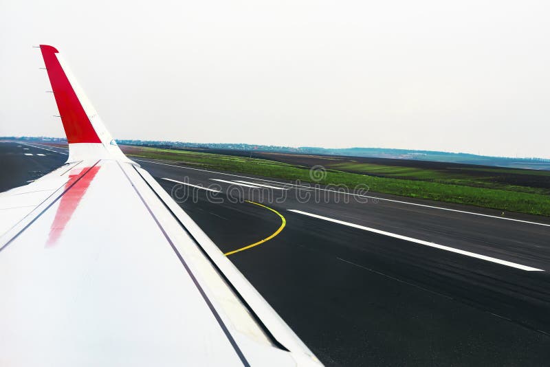 Airplane Wing Extends Over the Runway Stock Photo - Image of ailerons ...