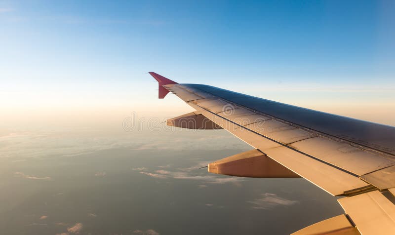 Airplane Wing in Flight from Window with Sunset Sky Stock Photo - Image ...