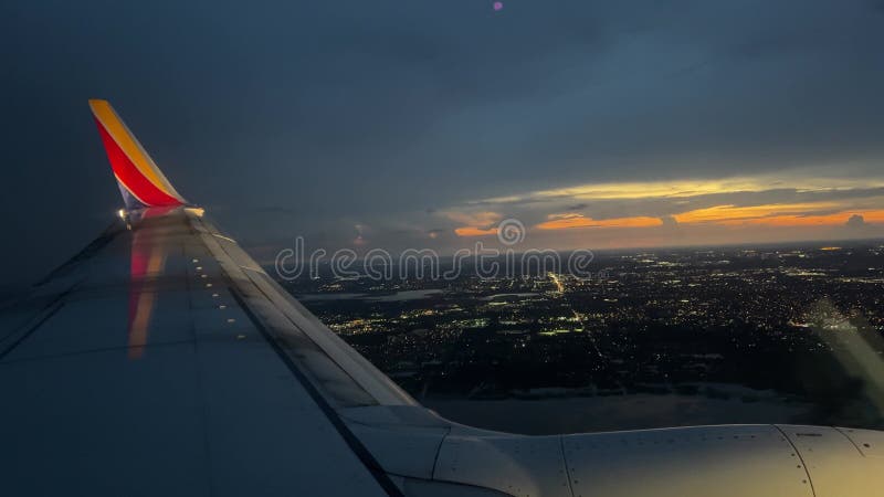 Southwest Airplane Wing Flying Above the Clouds on an Evening with a ...