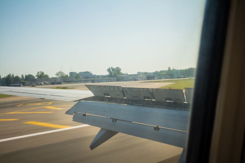 Airplane Wing during Landing with Flaps Down on the Runway Stock Image ...