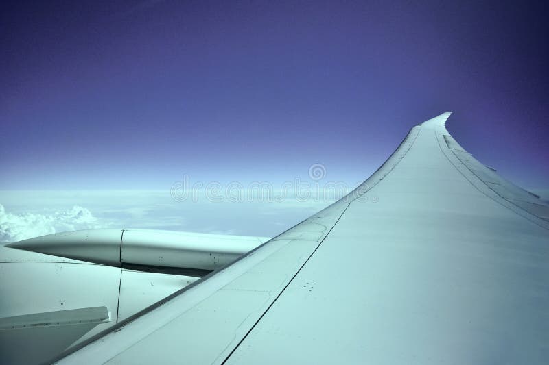 Airplane Wing in mid sky stock photo. Image of lens - 125683512