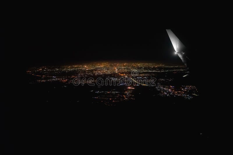 Airplane Wing at Night Over the City Stock Photo - Image of lamp, dark ...