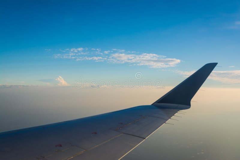 Airplane Wing Over Blue Daytime Clouds Stock Photo - Image of wing ...