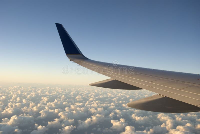 Airplane Wing Over Clouds Viewed Form the Cabin Stock Photo - Image of ...