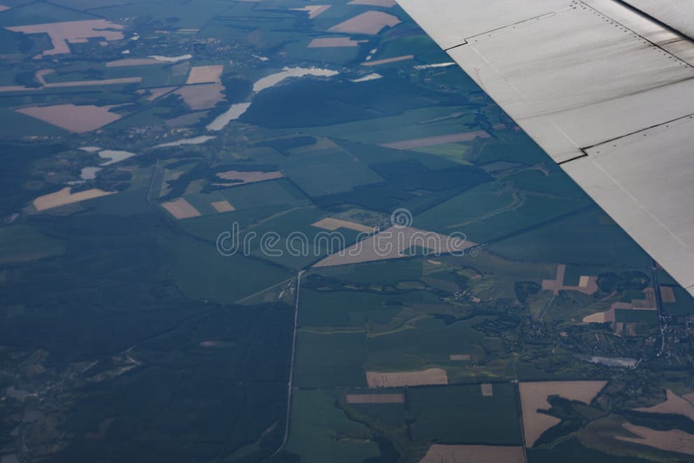 Airplane Wing Over Squares of Fields Stock Photo - Image of aviation ...