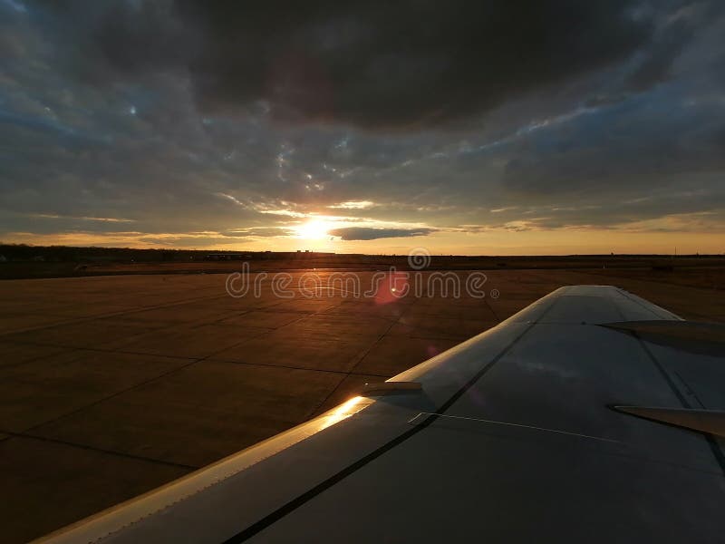 On airplane wing in sunset stock photo. Image of light - 179711236