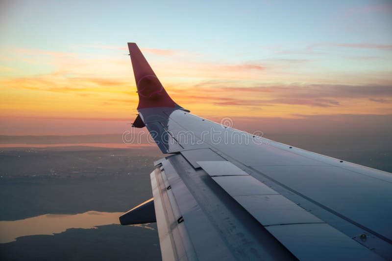 Airplane wing at sunset stock image. Image of aeroplane - 260882393