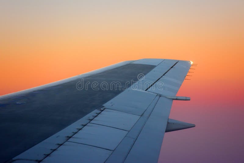 Airplane wing on sunset stock photo. Image of atmosphere - 72658848