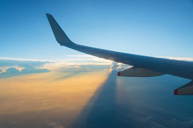 Airplane wing at sunset stock image. Image of sunset - 144999769