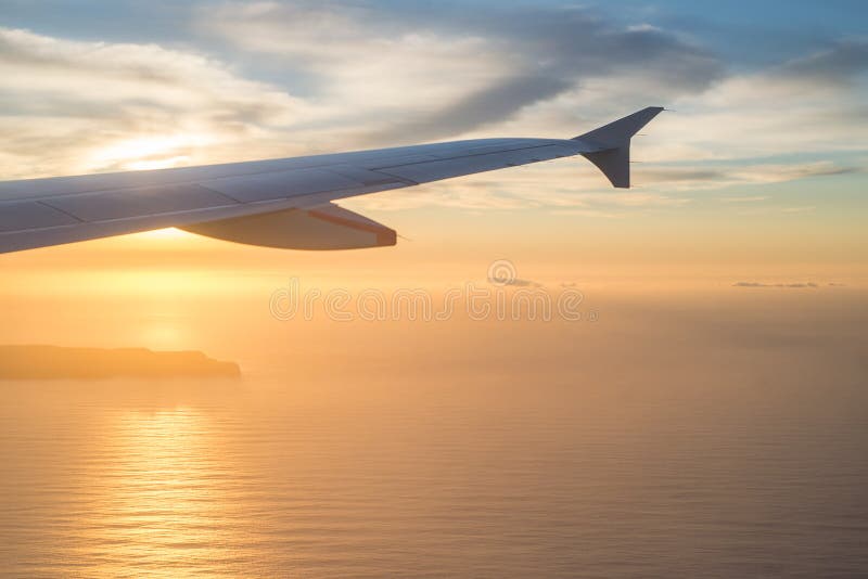 Airplane Wing Sunset View with Small Island and Ocean Stock Image ...