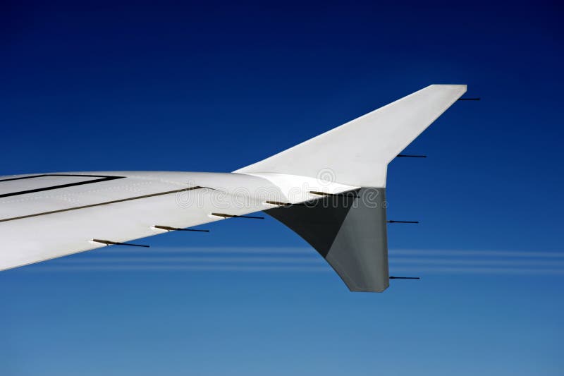 Airplane Wing Tip on Blu Sky Stock Image - Image of industry, stopped ...
