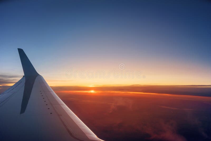 Airplane Wing during a Vibrant Sunset. Stock Image - Image of cloud ...
