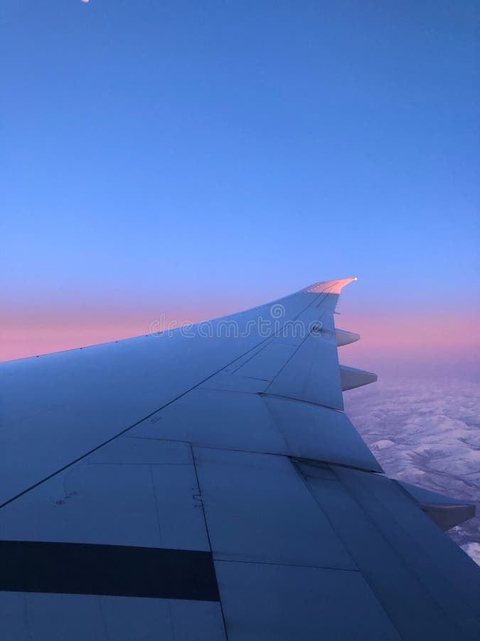 Airplane Wing View from Airplane Window during Pink Sunset Stock Photo ...