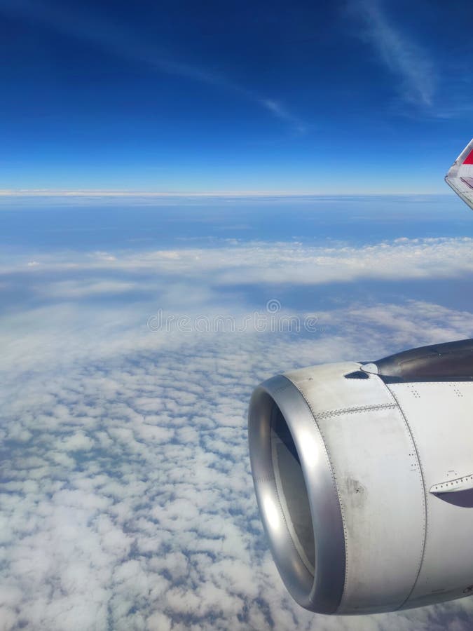 Airplane Wing through the Window Aircraft during Flight with a Blue Sky ...