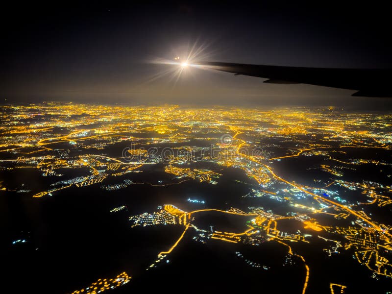 Airplane Wing from the Window at Night. Flight Over the Glowing City ...