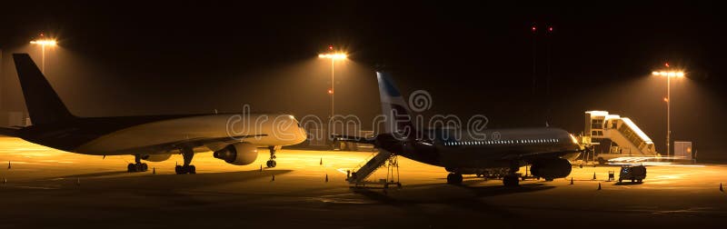 Airplanes at an Airport at Night Stock Photo - Image of lights, truck ...