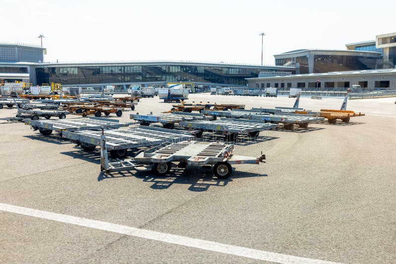 Airport Malpensa in Milan with the Carts and Passenger Planes Preparing ...