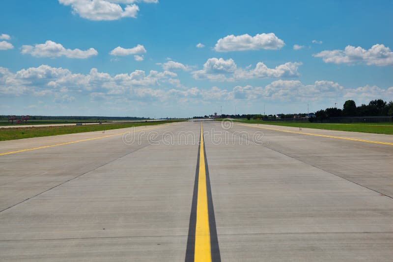Rural Airport Runway with Bright Yellow Line and Golden Wheatfield ...
