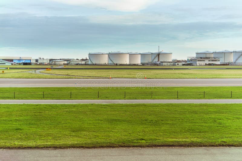 Airport Runway in Front of Fuel Storage Tanks and Industrial Storage ...