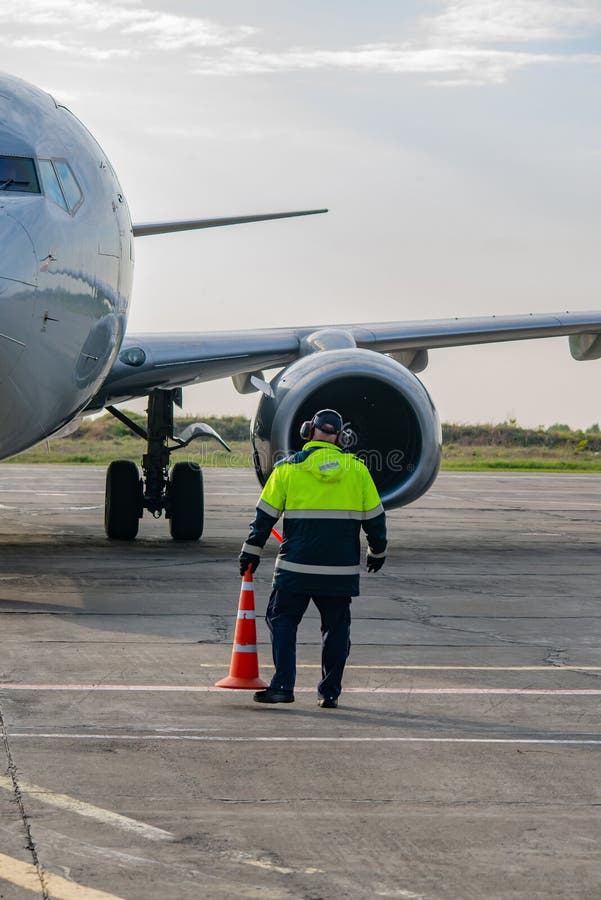 Airport Security Guard Standing in Front of an Airplane with Cone Stock ...