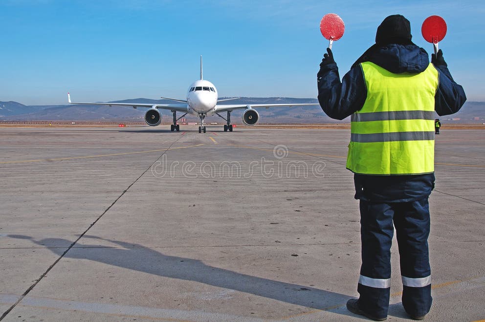 Airport worker directing stock photo. Image of light - 83125346