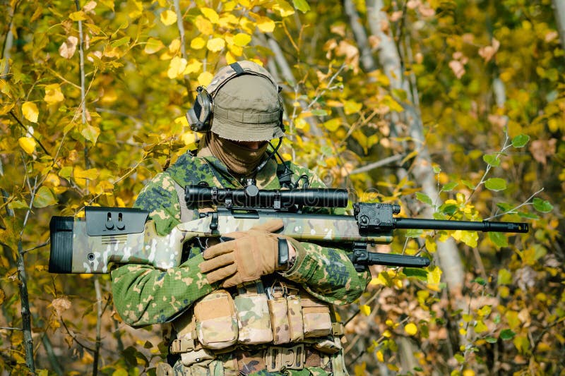 Airsoft Man in Uniform Hold Sniper Rifle on Yellow Forest Backdrop ...