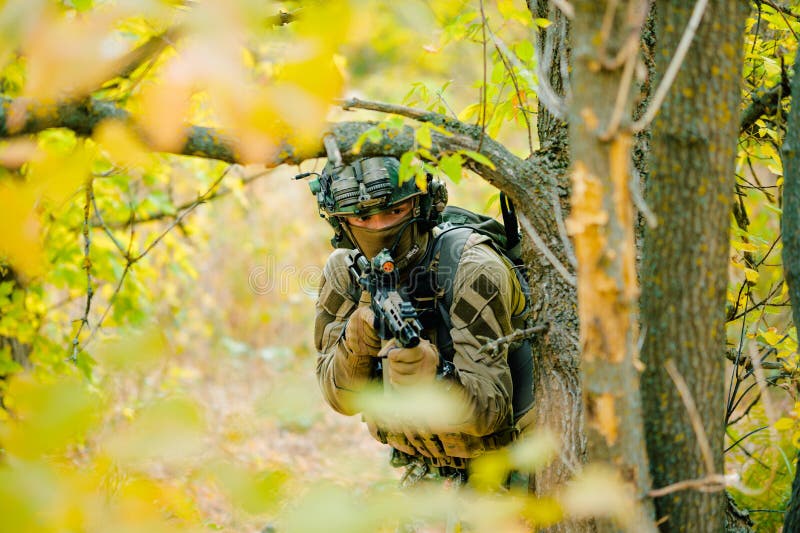 Airsoft Man in Uniform with Machine Gun beside Tree in the the Forest ...
