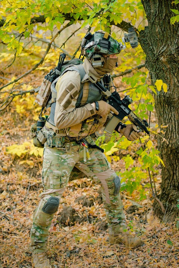 Airsoft Man in Uniform beside Tree Move with Machine Gun. Side View ...