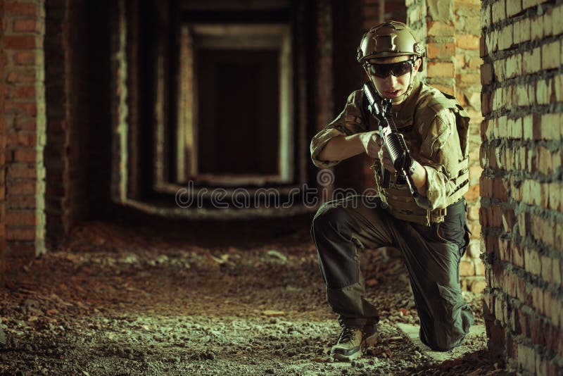 Airsoft Soldier with a Rifle Playing Strikeball in Brick Building Stock ...