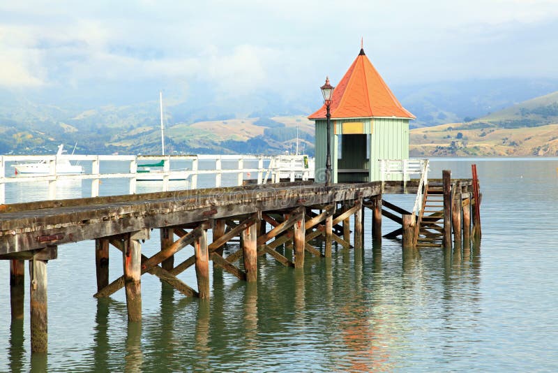 Akaroa jetty New Zealand stock image. Image of beach - 19843873