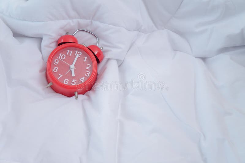 Alarm clock on the bed stock image. Image of bedroom - 92667683