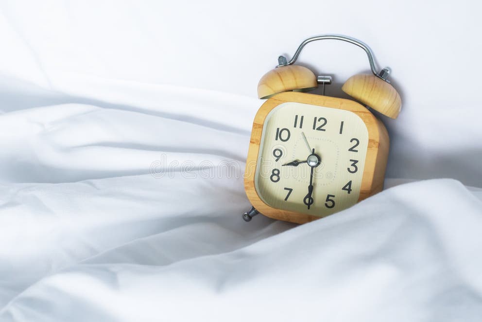 Alarm Clock at 8 in Bed with White Blanket Stock Photo - Image of ...
