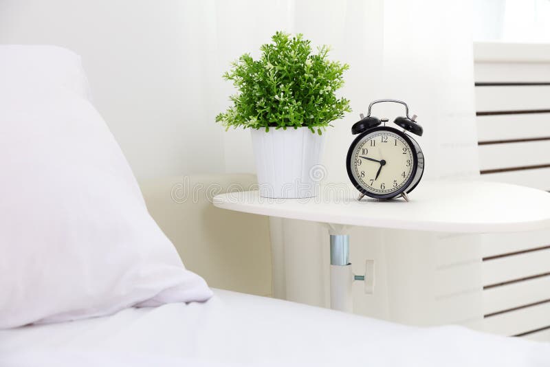 Alarm Clock in Bedroom Near Bed Stock Photo - Image of room, house ...