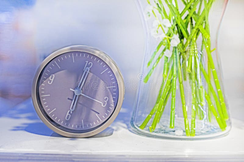 Alarm Clock on a Bedside Table with Flowers. Good Morning Stock Photo ...