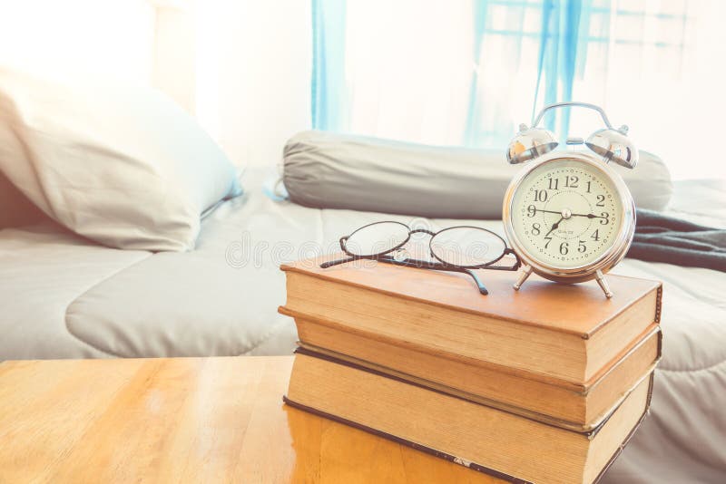 Alarm clock with book stock photo. Image of bell, early - 88682054
