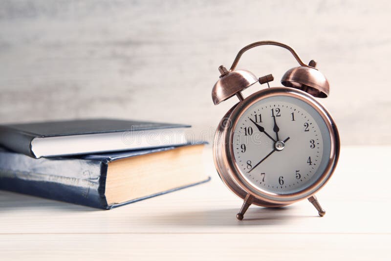 Alarm Clock with a Book on the Table Stock Photo - Image of cabinet ...