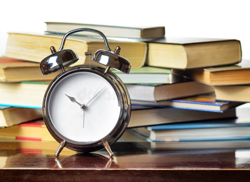 Alarm clock and books stock image. Image of book, expertise - 40916049