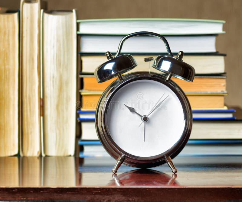 Alarm clock and books stock photo. Image of book, back - 40916178