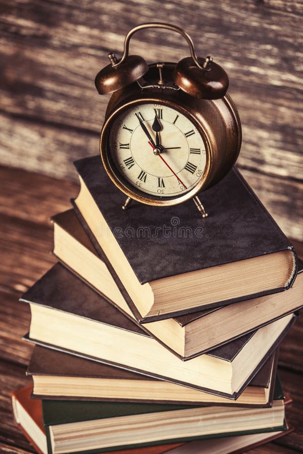 Alarm clock and books stock image. Image of time, bokeh - 41592701