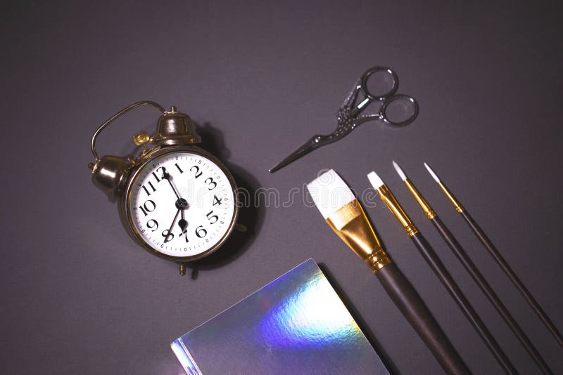 Alarm Clock, Brush Set, Scissors and Holographic Notepad on the Grey ...
