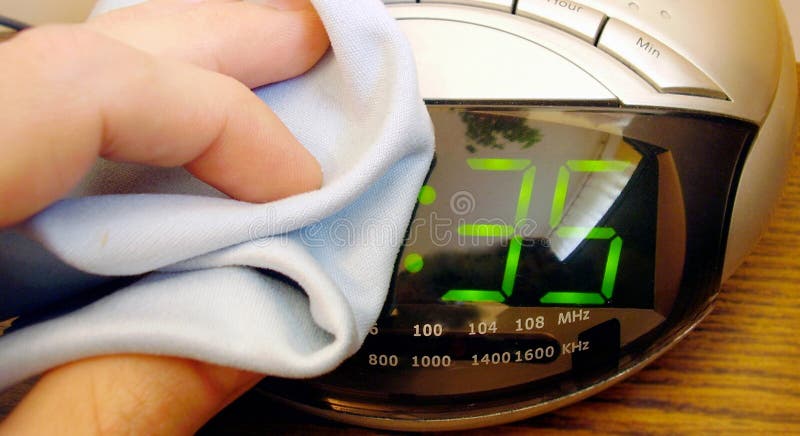 Alarm clock cleaning stock image. Image of clean, dust - 4469521