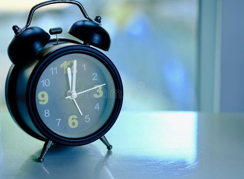 Alarm Clock on Desk at Noon Stock Photo - Image of alarm, noon: 141781322