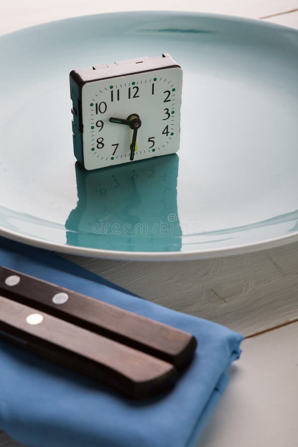 Alarm clock on a a plate stock image. Image of fork - 139464601